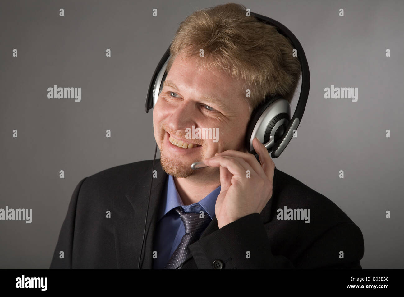 the portrait of man with headphone on grey background Stock Photo - Alamy