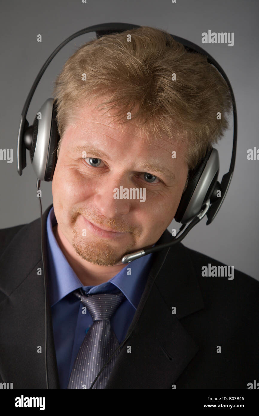 the portrait of man with headphone on grey background Stock Photo - Alamy