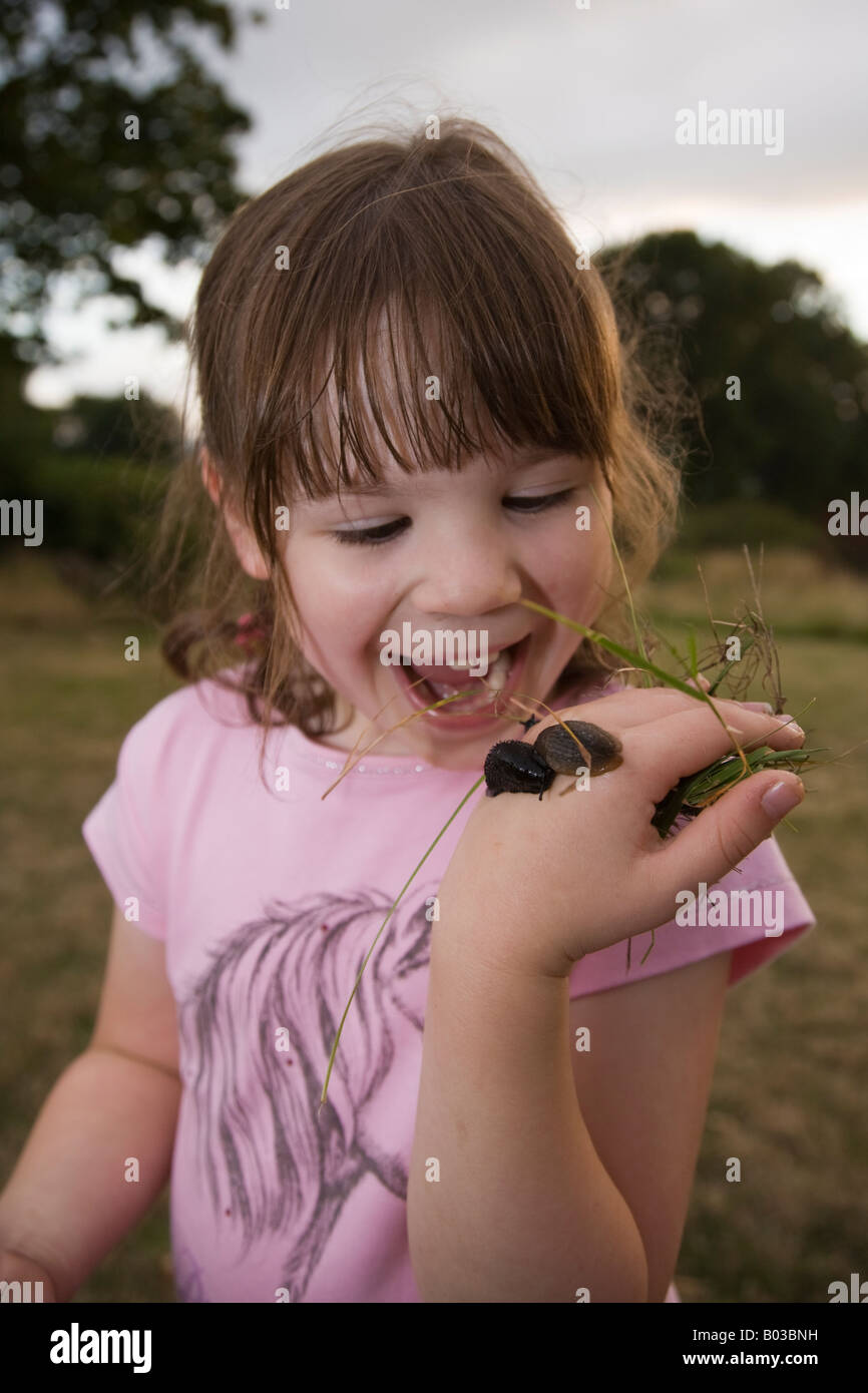 Young girl laughing with slugs on the back of her hands Stock Photo - Alamy