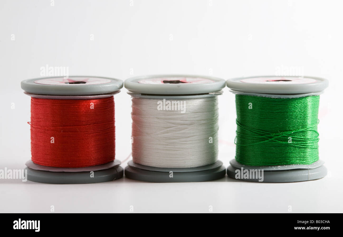 Sewing thread in three colours Stock Photo - Alamy