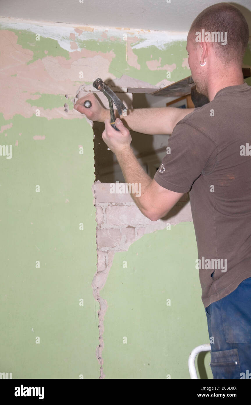 Chopping out brickwork for new opening in wall Stock Photo - Alamy