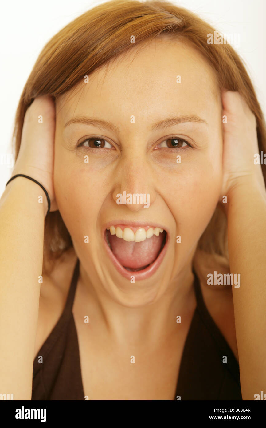 woman with hands over her ears shouting /screaming Stock Photo - Alamy