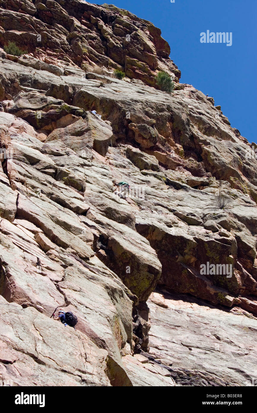 Several mountain climbers climb a sheer cliff face in Eldorado State ...