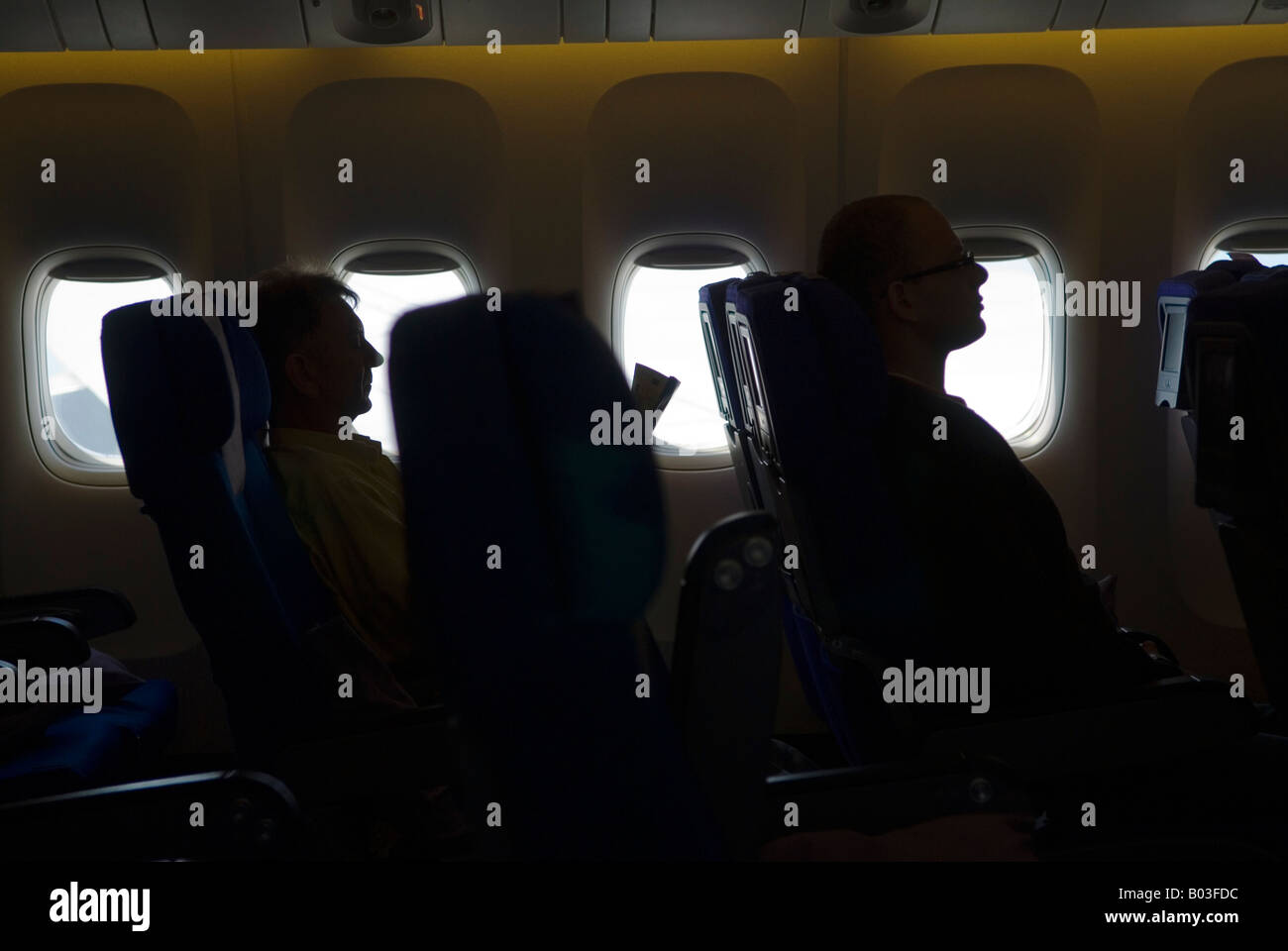 Airline passengers relax read newspaper book flightemergency ...