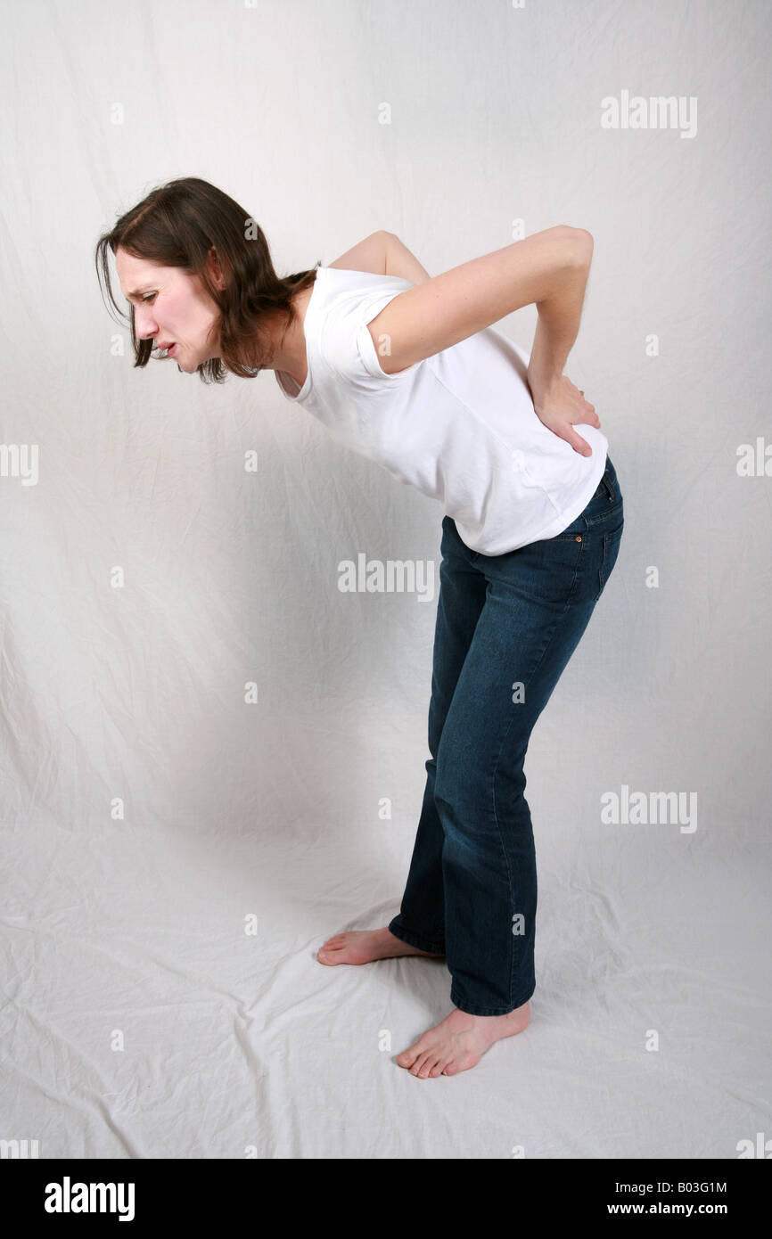 Woman bent over in pain hi-res stock photography and images - Alamy