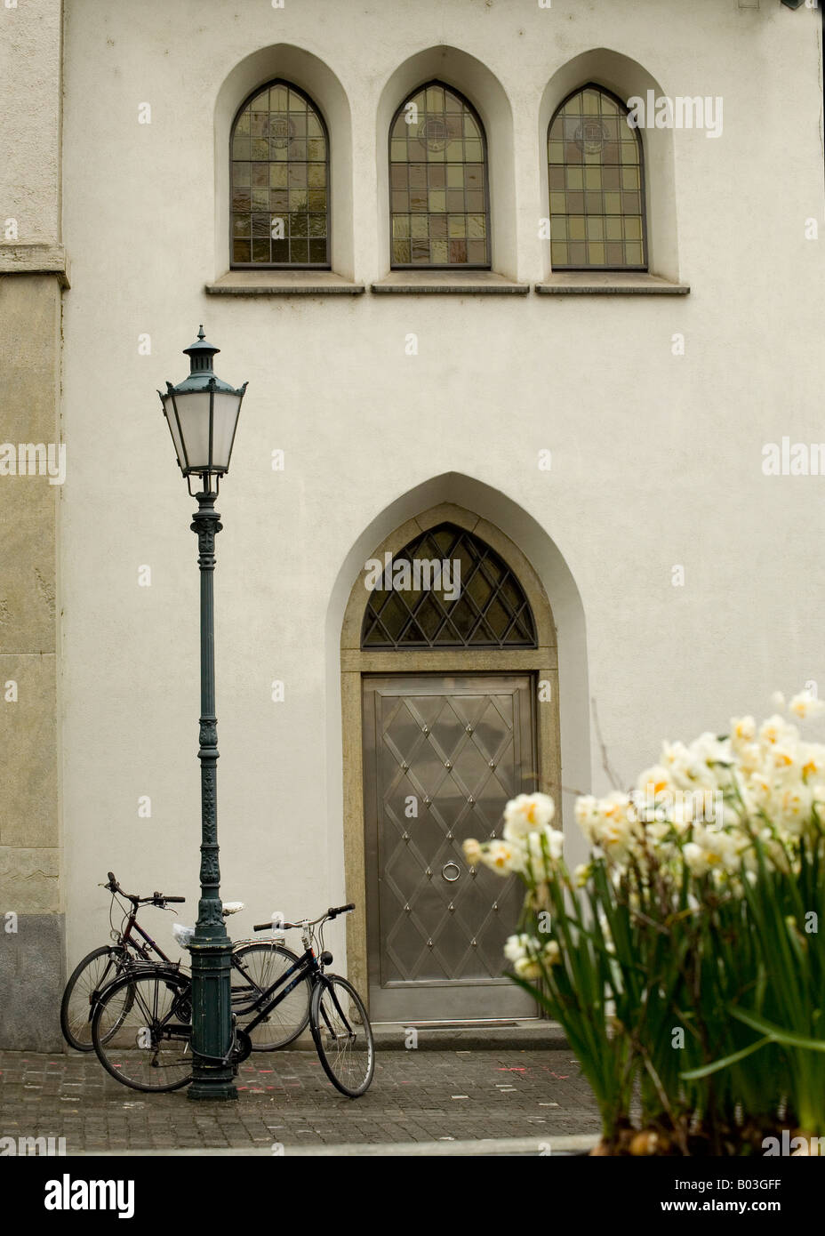 bicycles leaning against a traditional lamp post in old town of Zurich ...