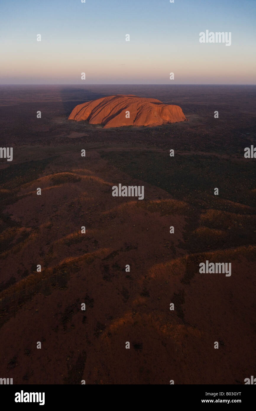 Aerial view of a glowing red Uluru (Ayres Rock) at Sunset Stock Photo ...