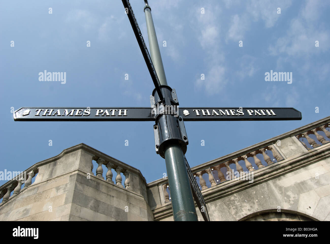 signpost marking the thames path, with chiswick bridge, which crosses ...