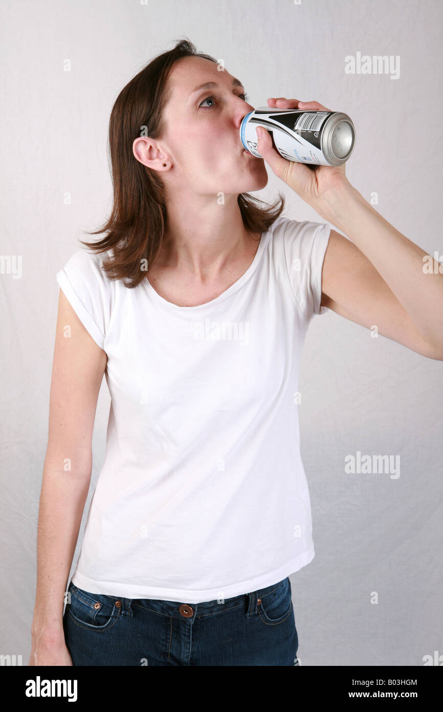 Young woman female drinking swigging beer alcohol from cheap can of ...