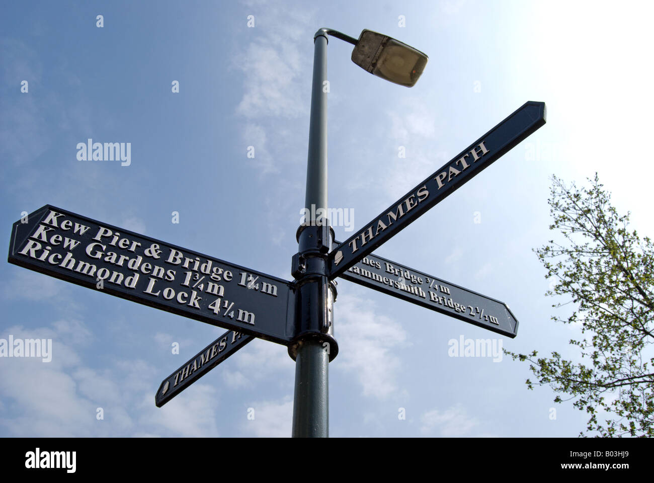 lamppost with signs marking the thames path, kew pier, kew gardens ...