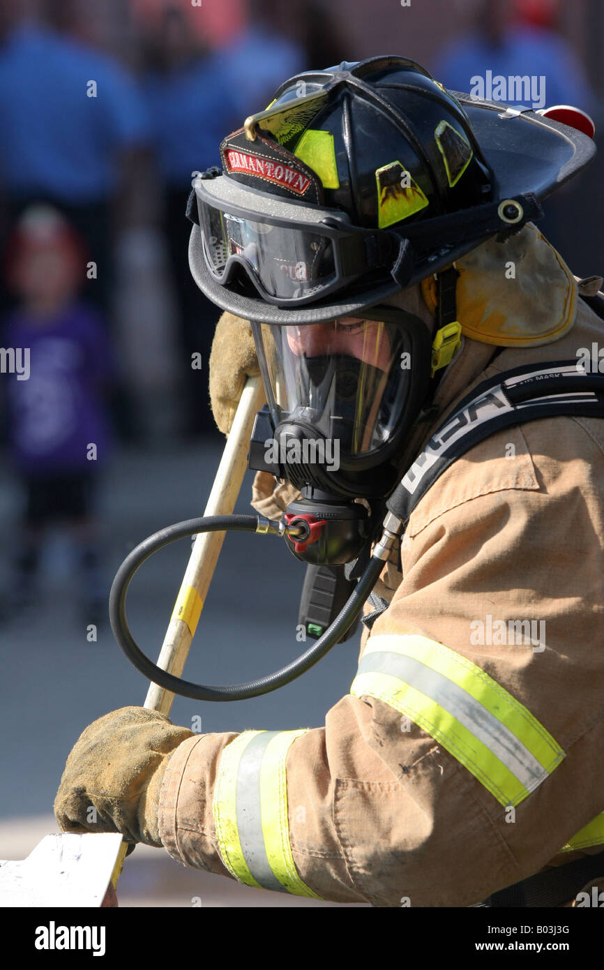 A firefighter using an ax during a demonstration Stock Photo - Alamy