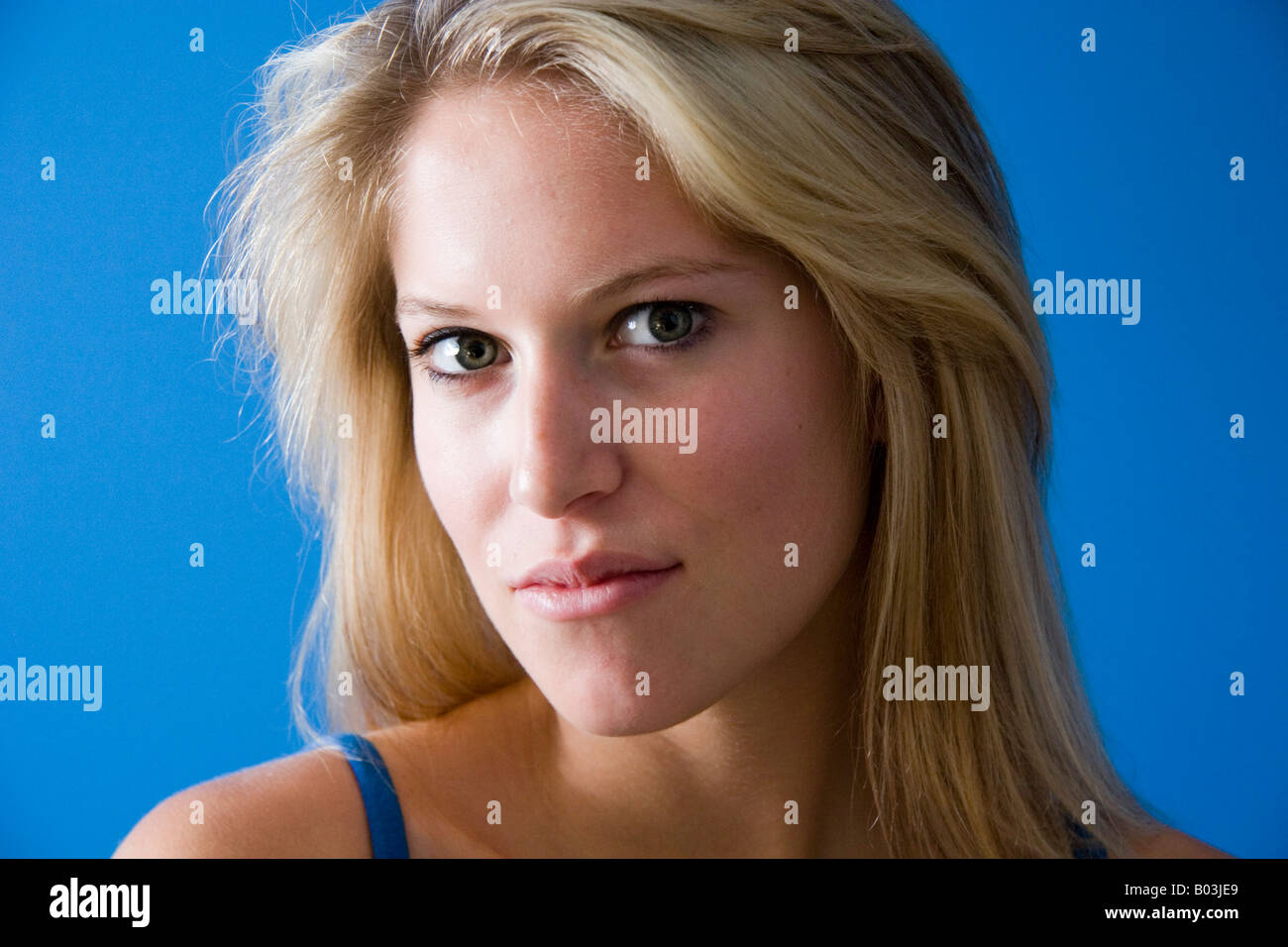 Close up of a young blond woman with a questioning or inquisitive look ...