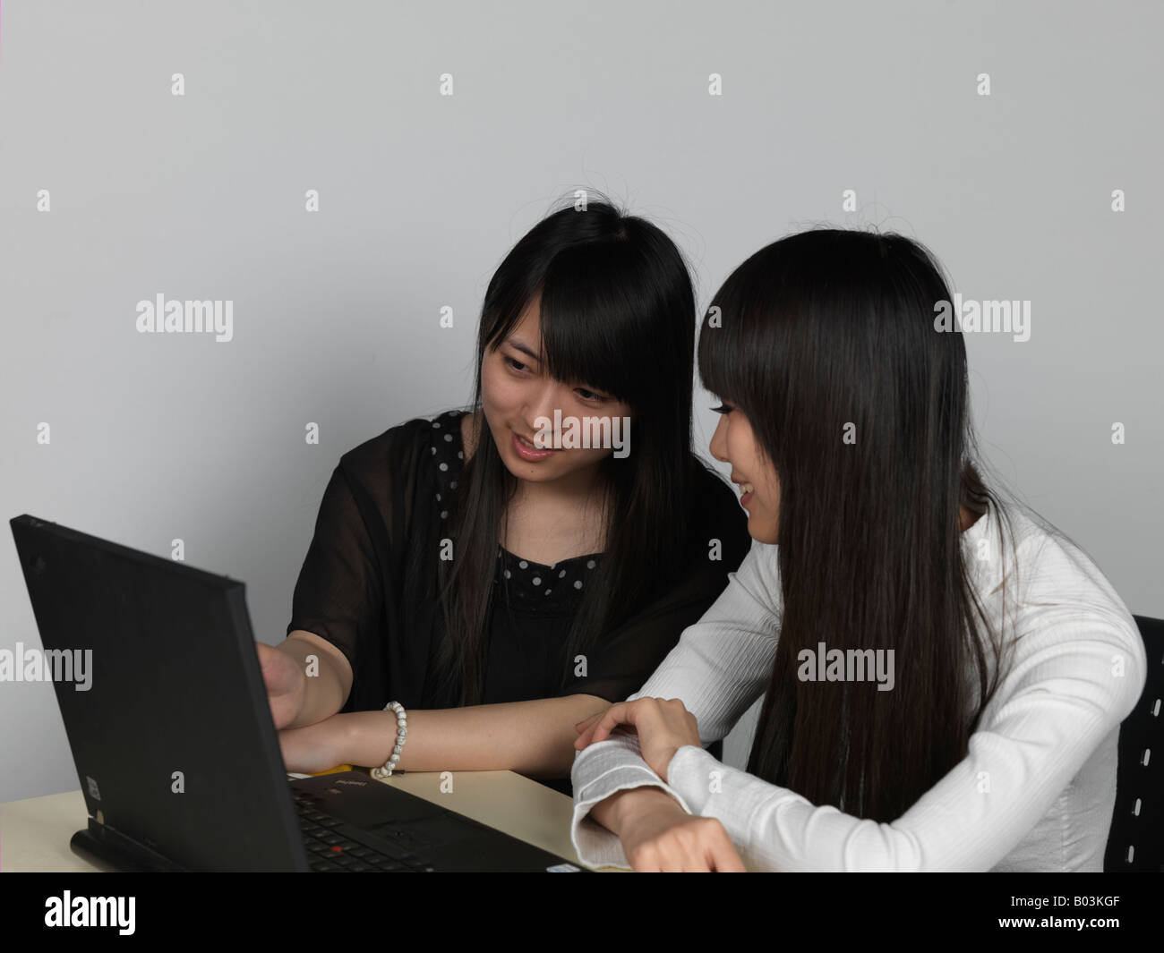 two ladys work together Stock Photo - Alamy