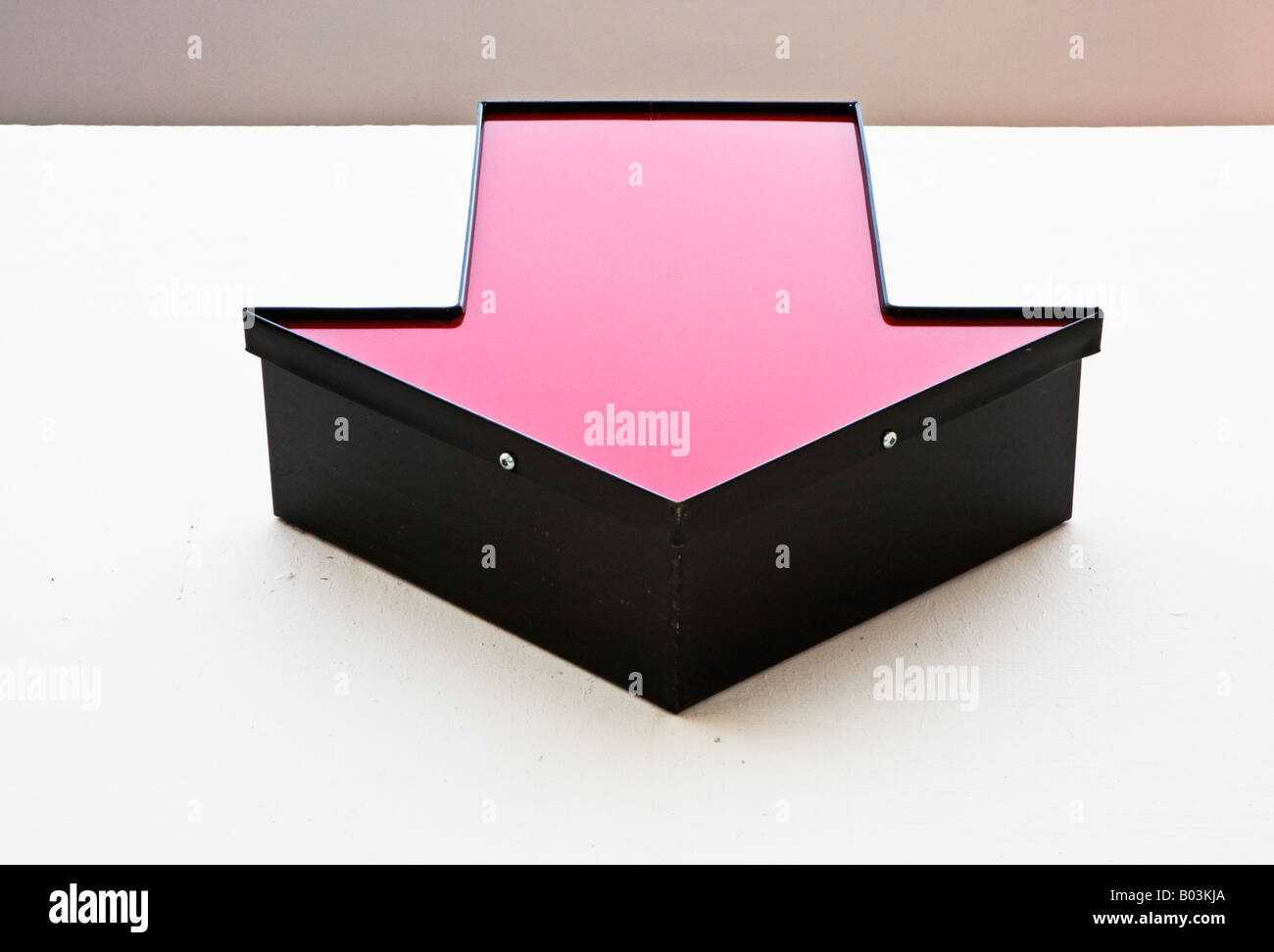 arrow on strip mall wall Stock Photo - Alamy