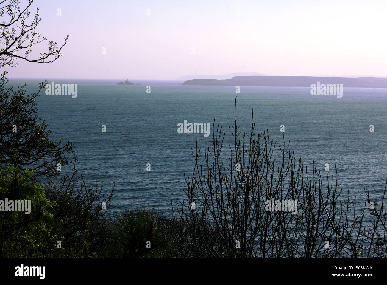 A view of a lighthouse in the distance by the sea Stock Photo - Alamy
