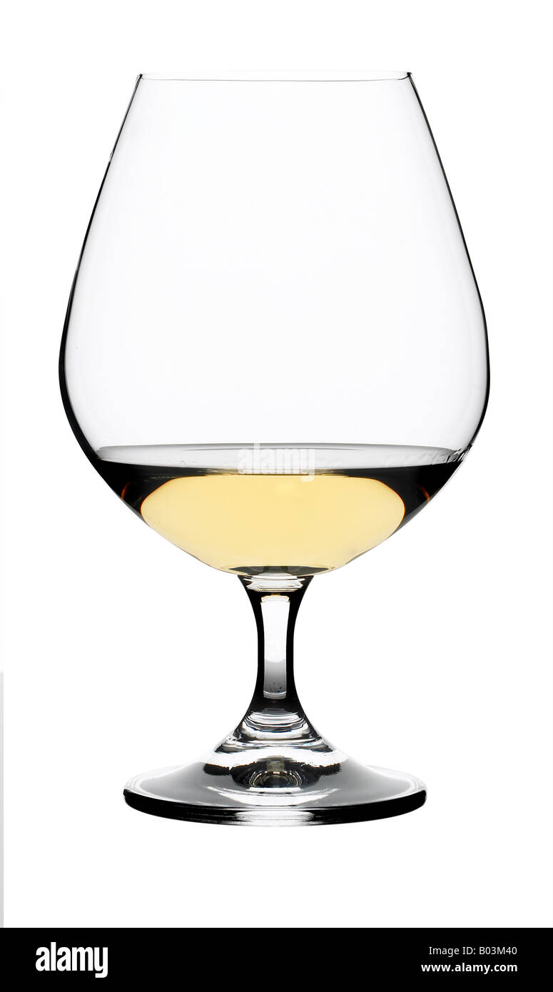 brandy glass with golden liquid Stock Photo - Alamy