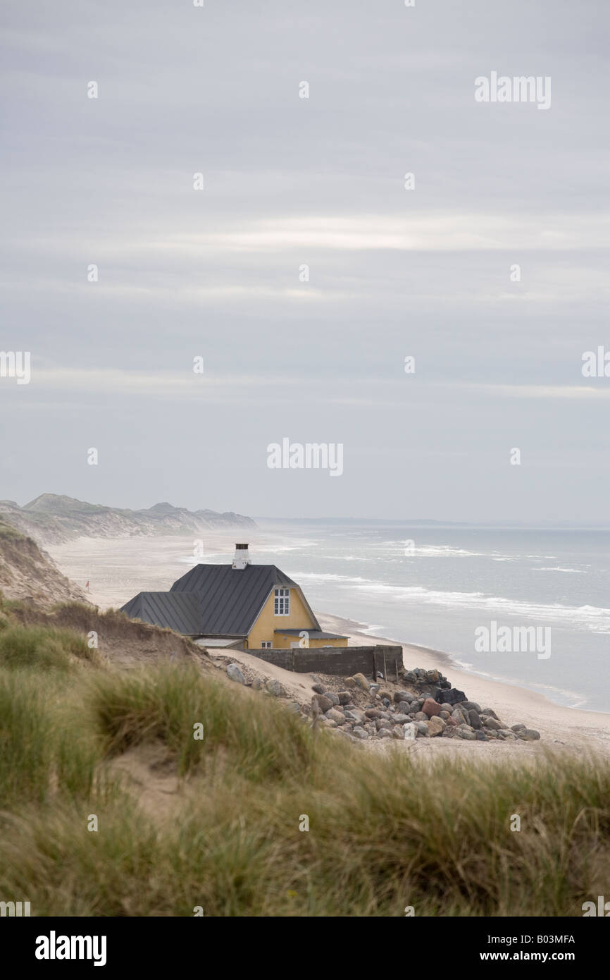 House on the Strand Vertical A yellow house clings to the shore ...