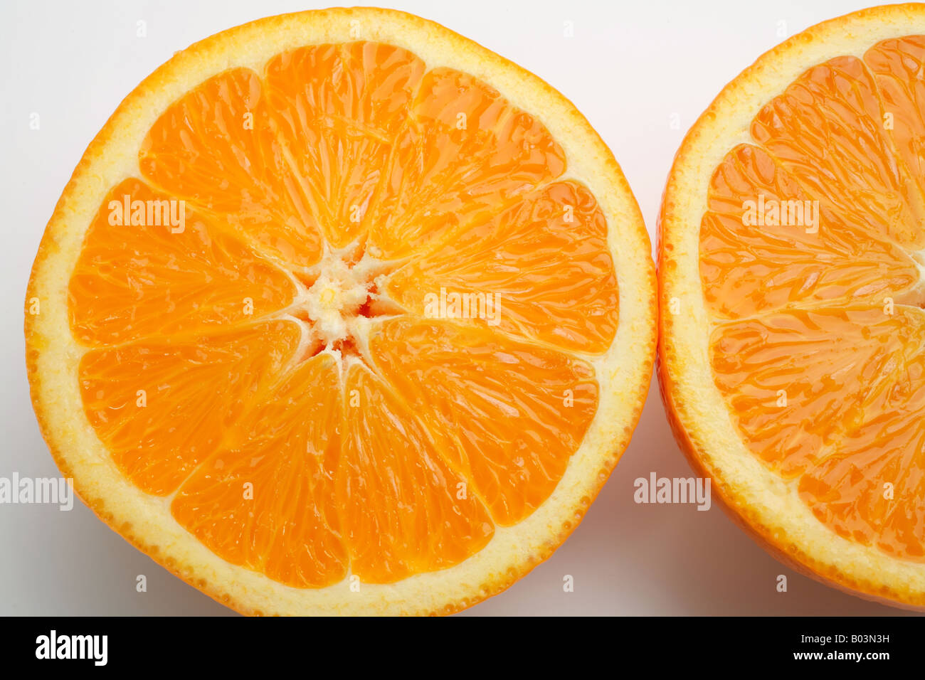 an orange cut in half showing one and a half orange slices Stock Photo ...