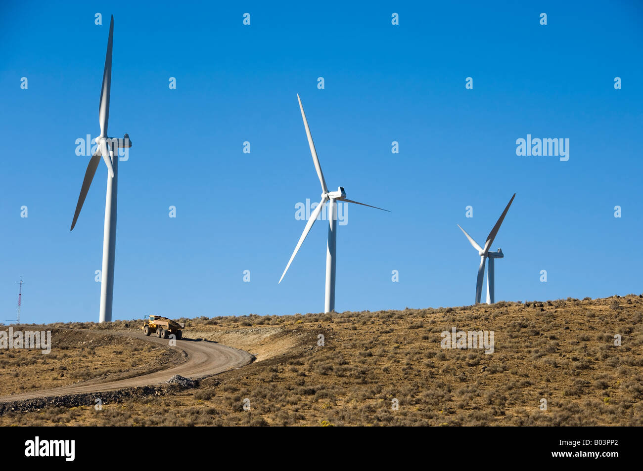 Dump truck beneath wind turbines in the desert Stock Photo - Alamy