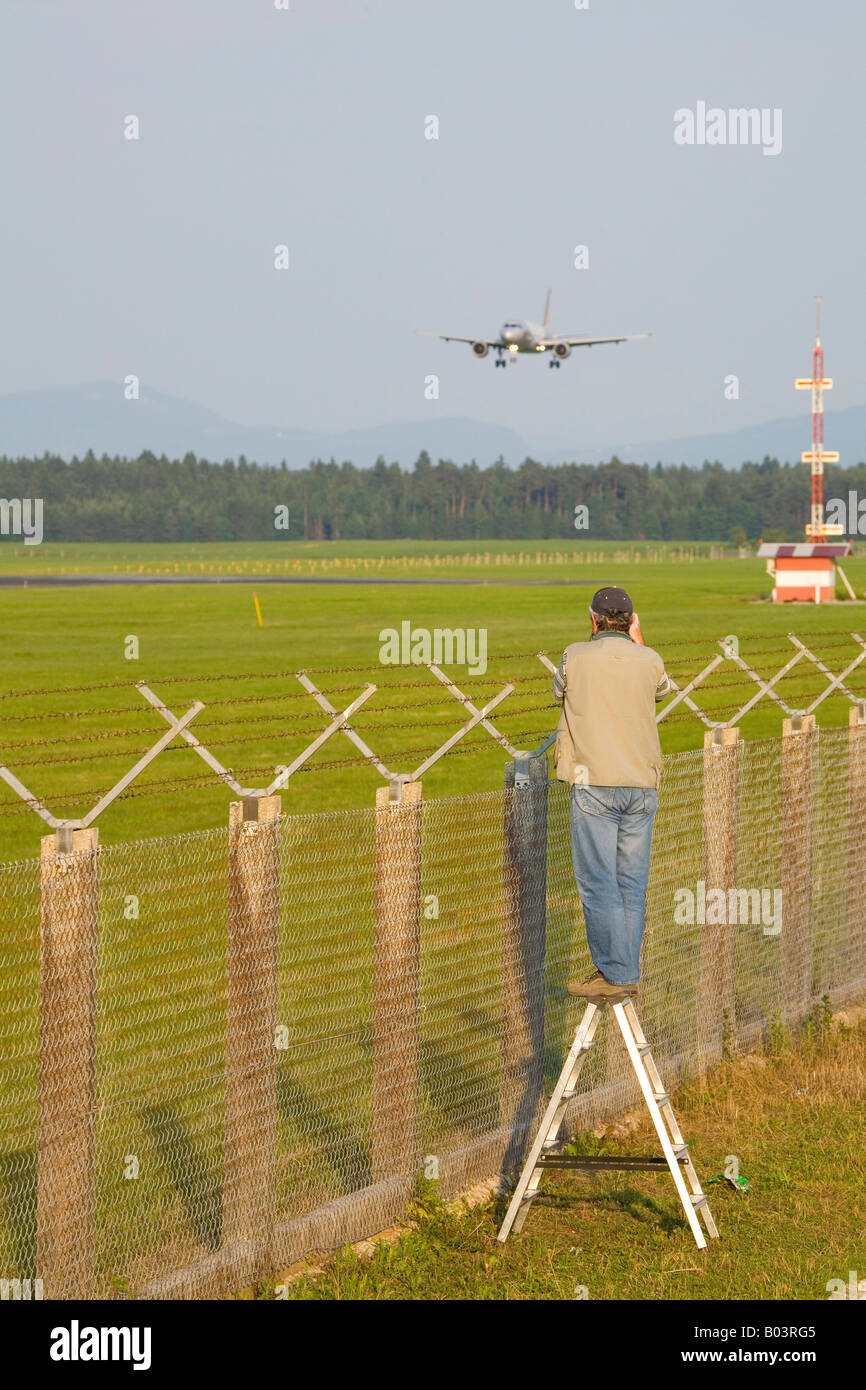 Man photographing aircraft landing hi-res stock photography and images ...
