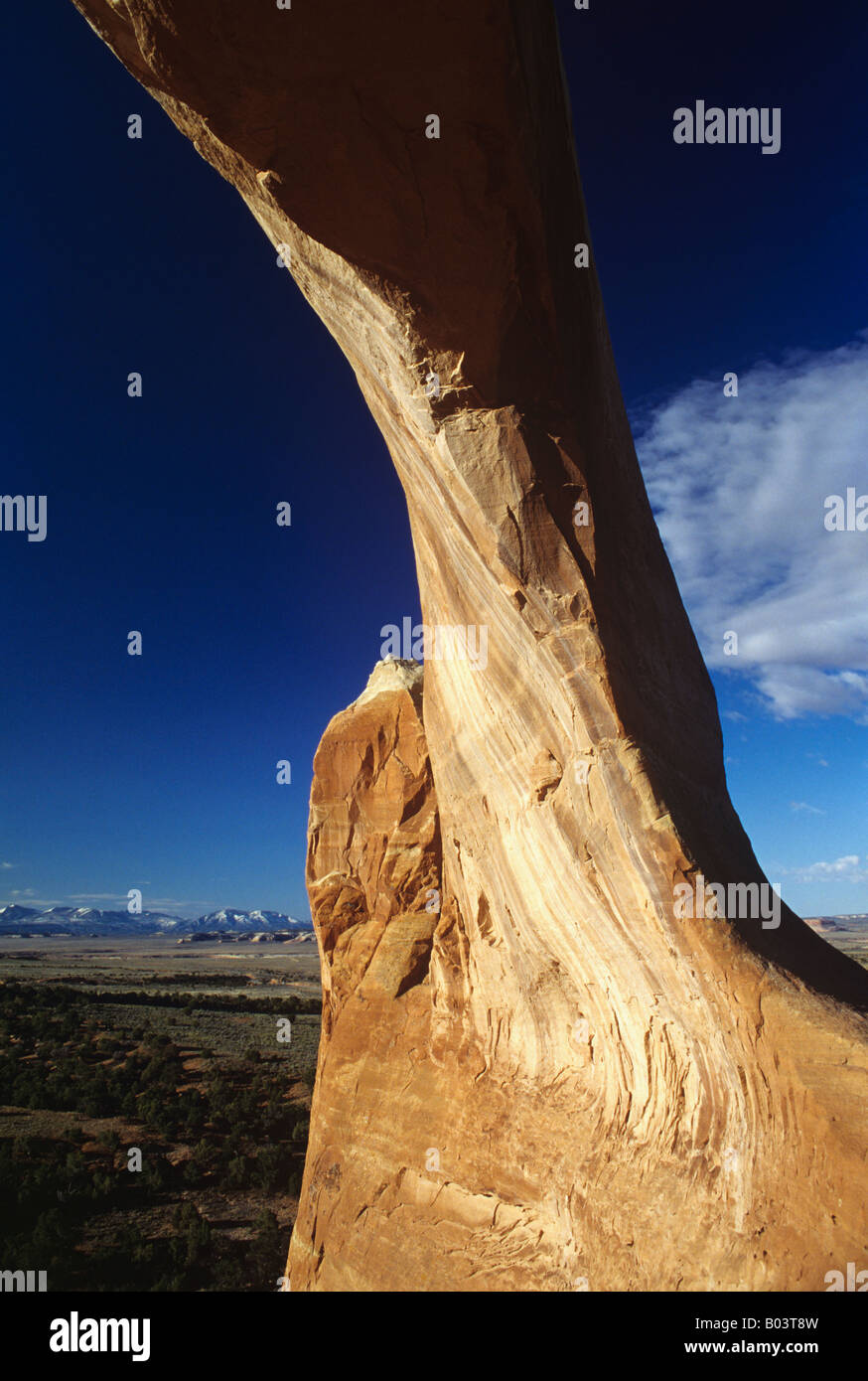 The base of Wilson Arch with the Abajo Mountains in the background ...