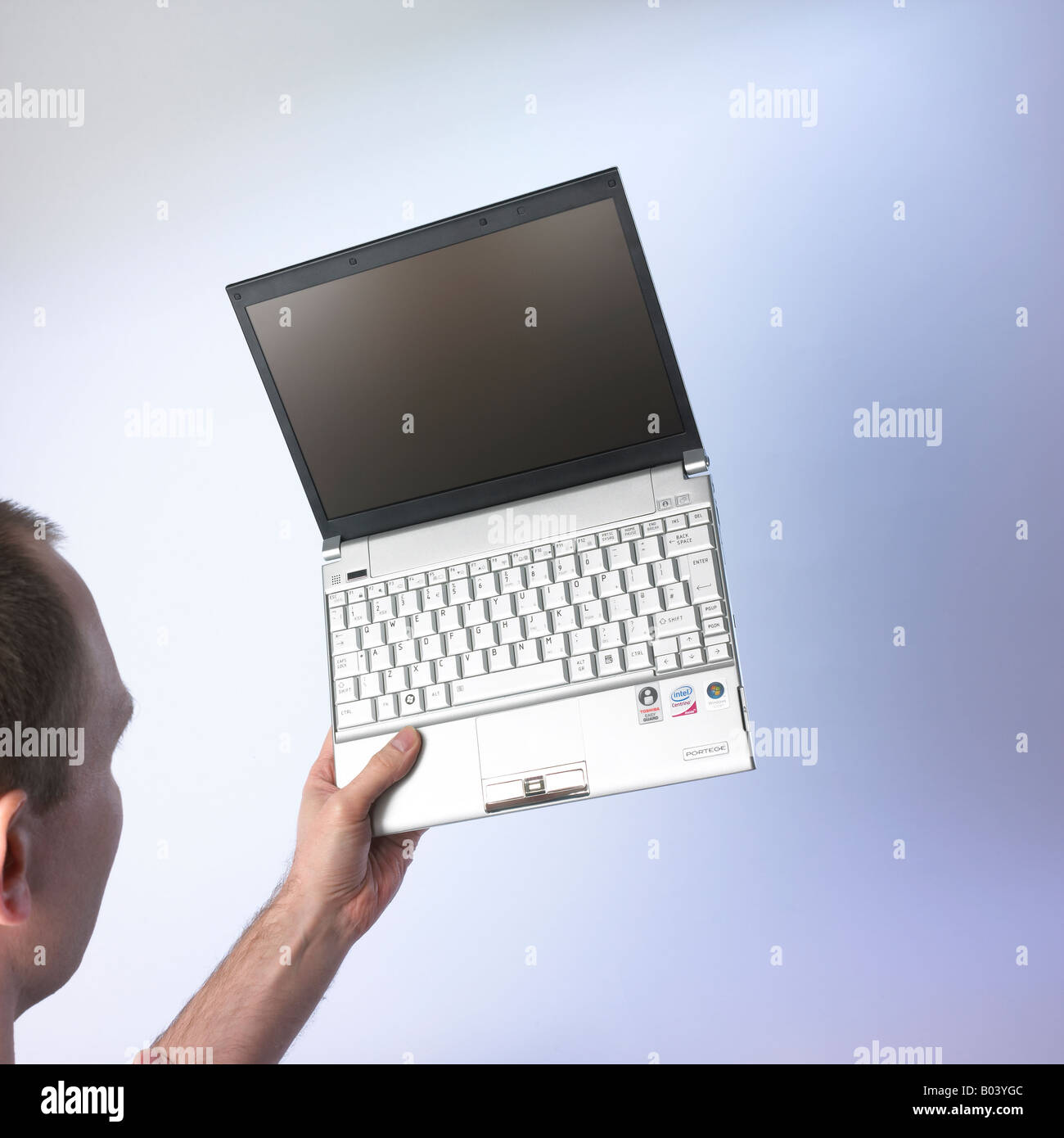 Laptop computer held by man Stock Photo - Alamy