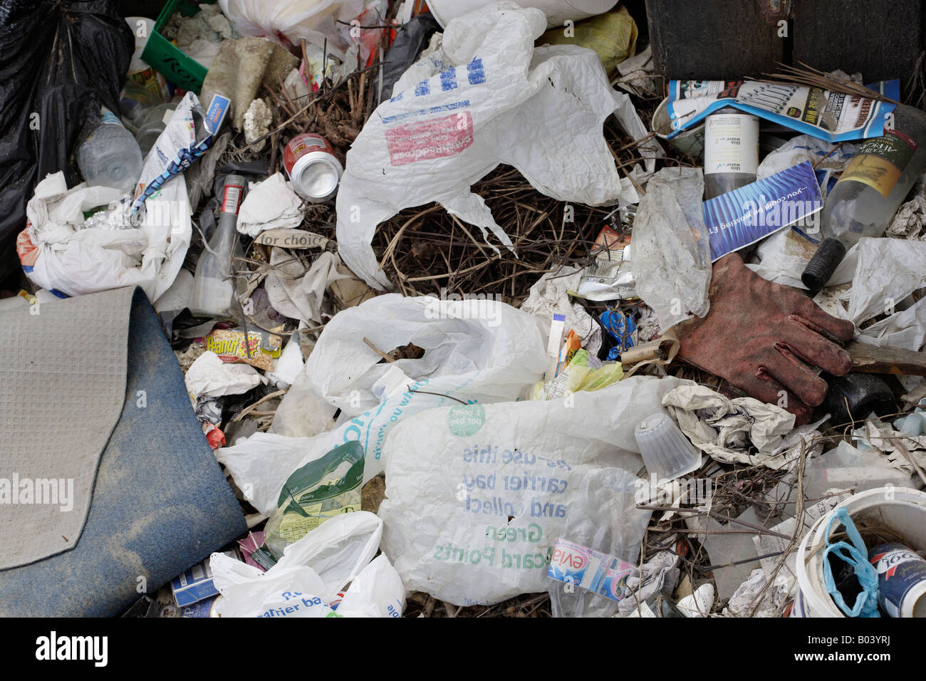 Broken rubbish bags with contents strewn about in an alley Stock Photo ...