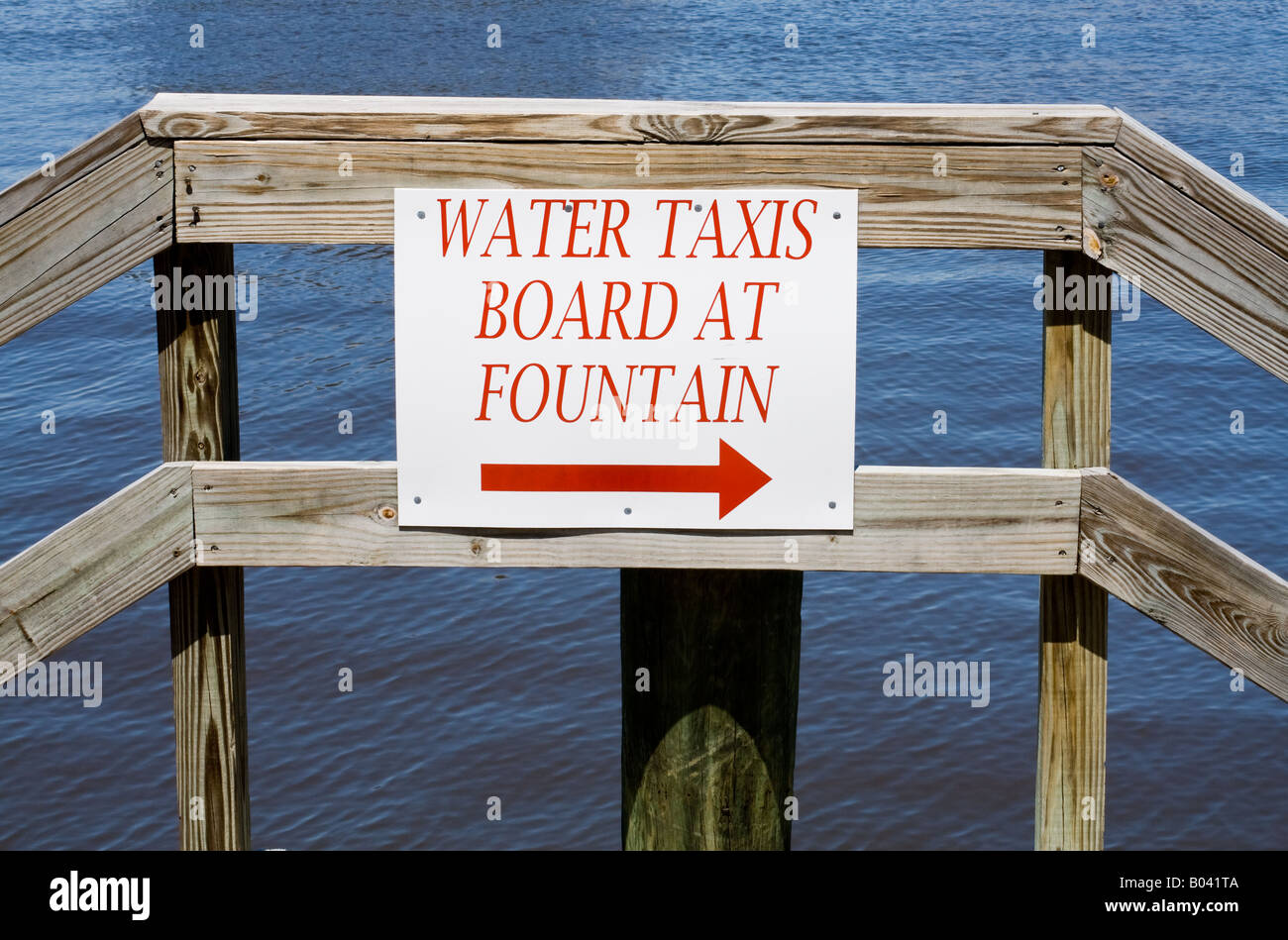 Sign for a water taxi on a wood fence by the river in Jacksonville ...