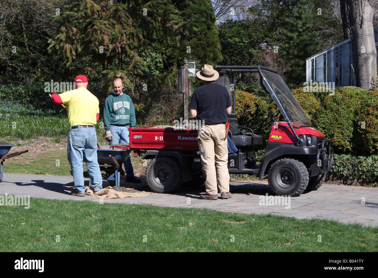 Three men getting ready to spread some mulch Stock Photo - Alamy