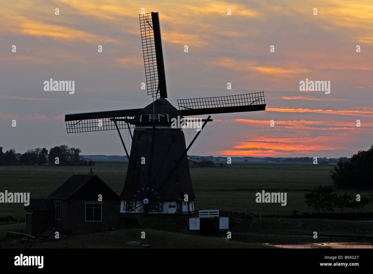 dutch windmill in red sunset island texel netherlands Stock Photo - Alamy