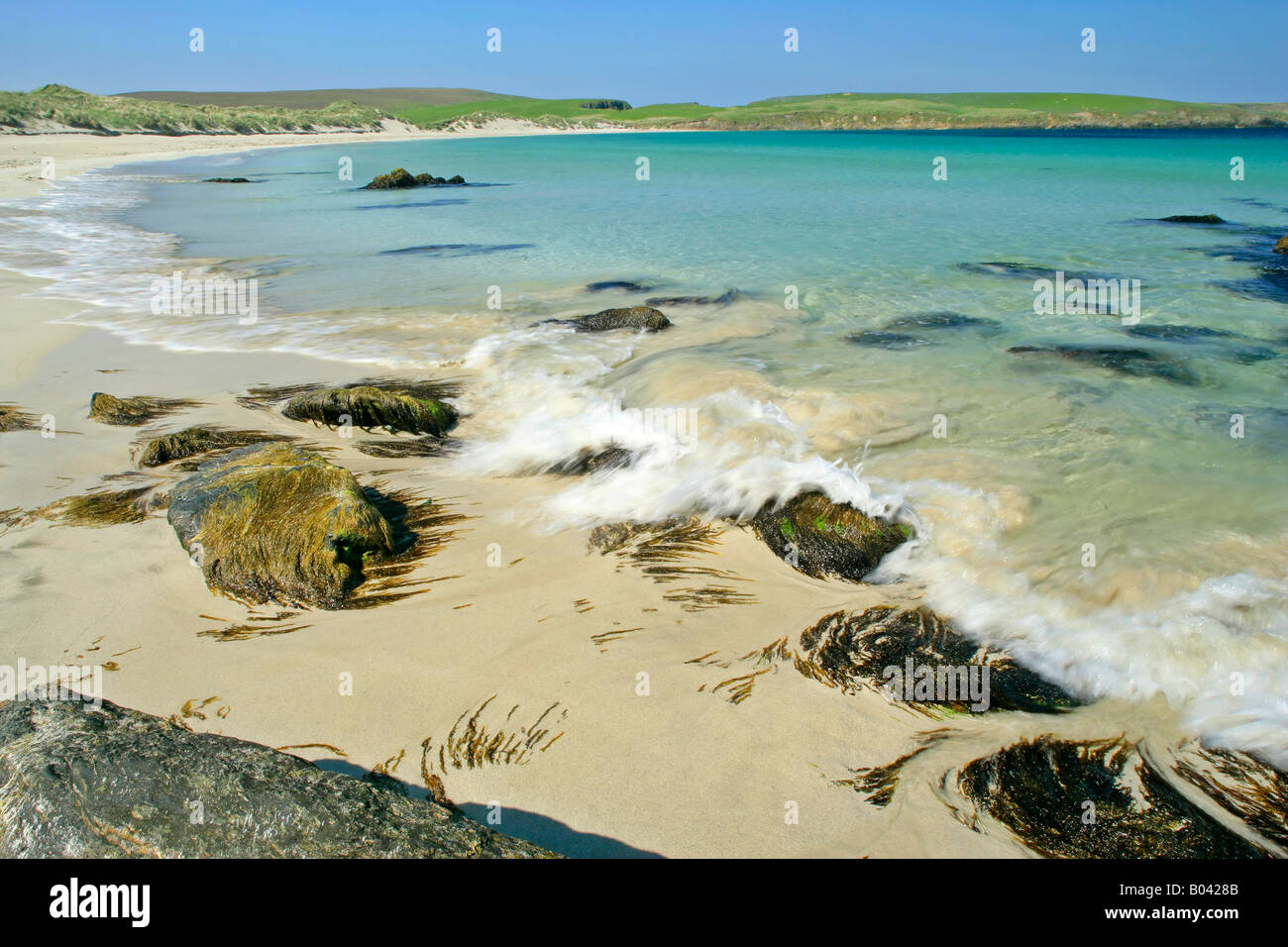 Summer beach approaching wave blue sea rocks and white sand at beach of ...
