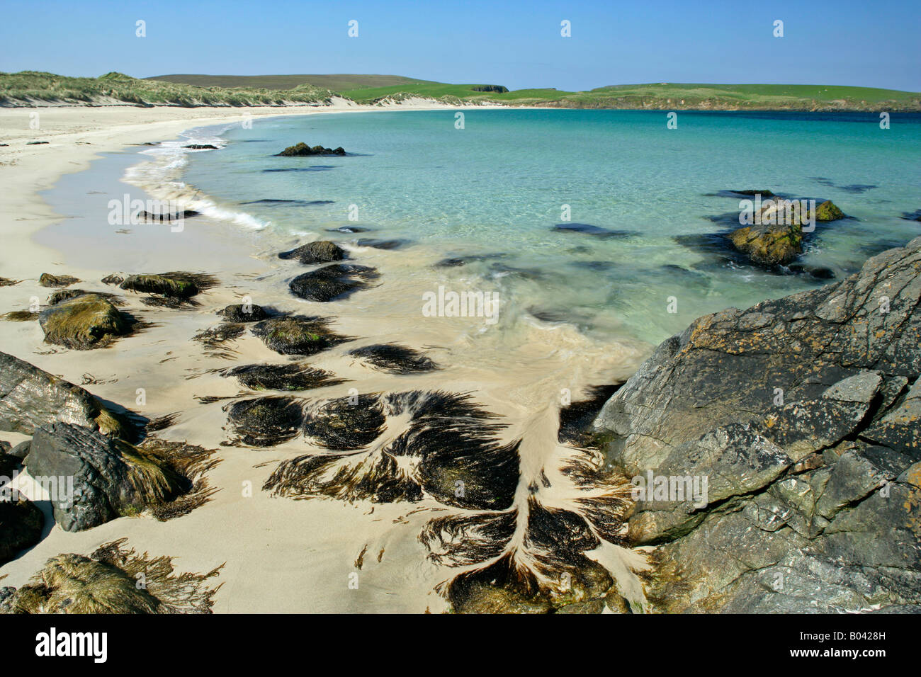 Summer beach approaching wave blue sea rocks and white sand at beach of ...