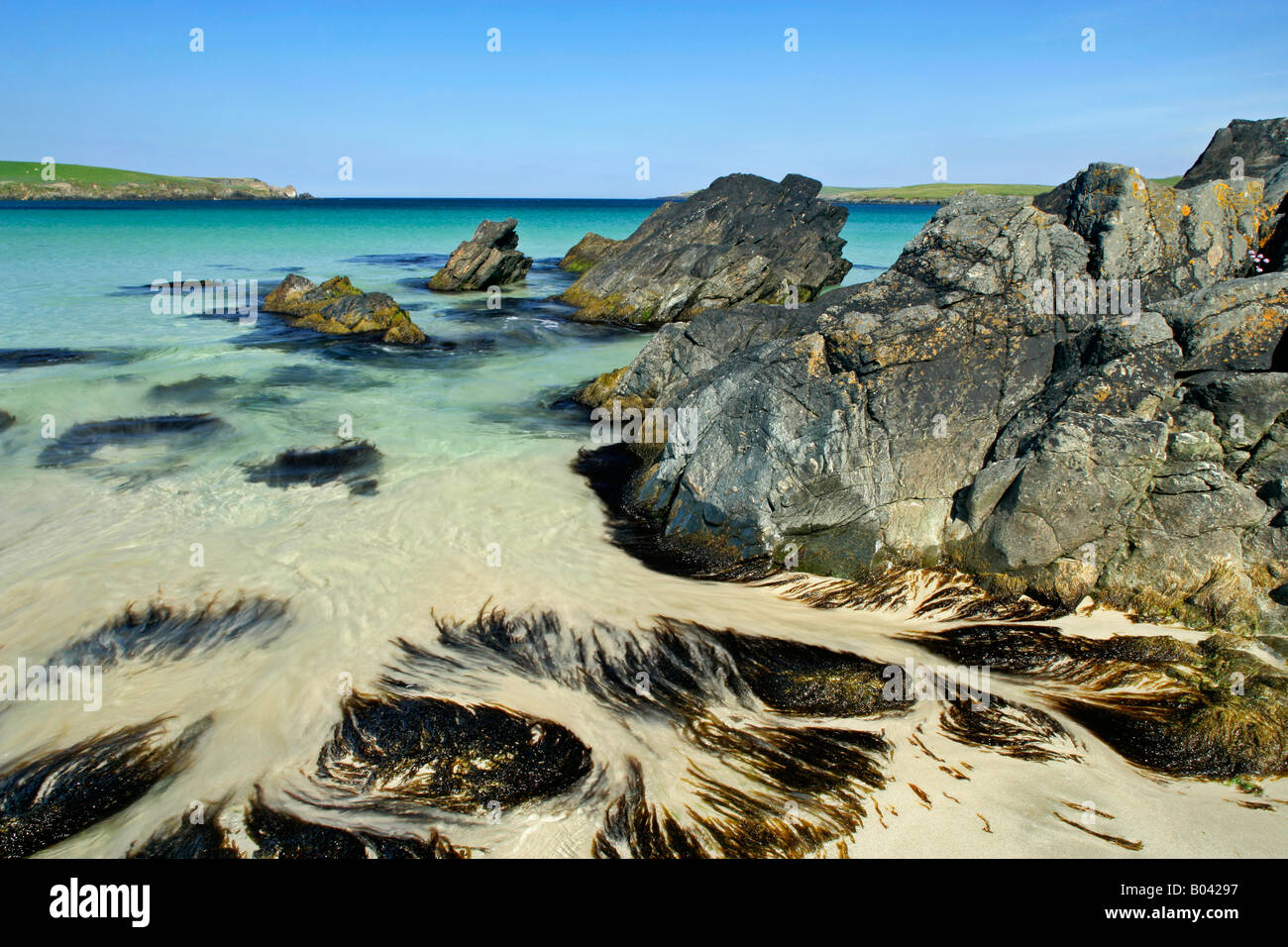 Summer beach approaching wave blue sea rocks and white sand at beach of ...