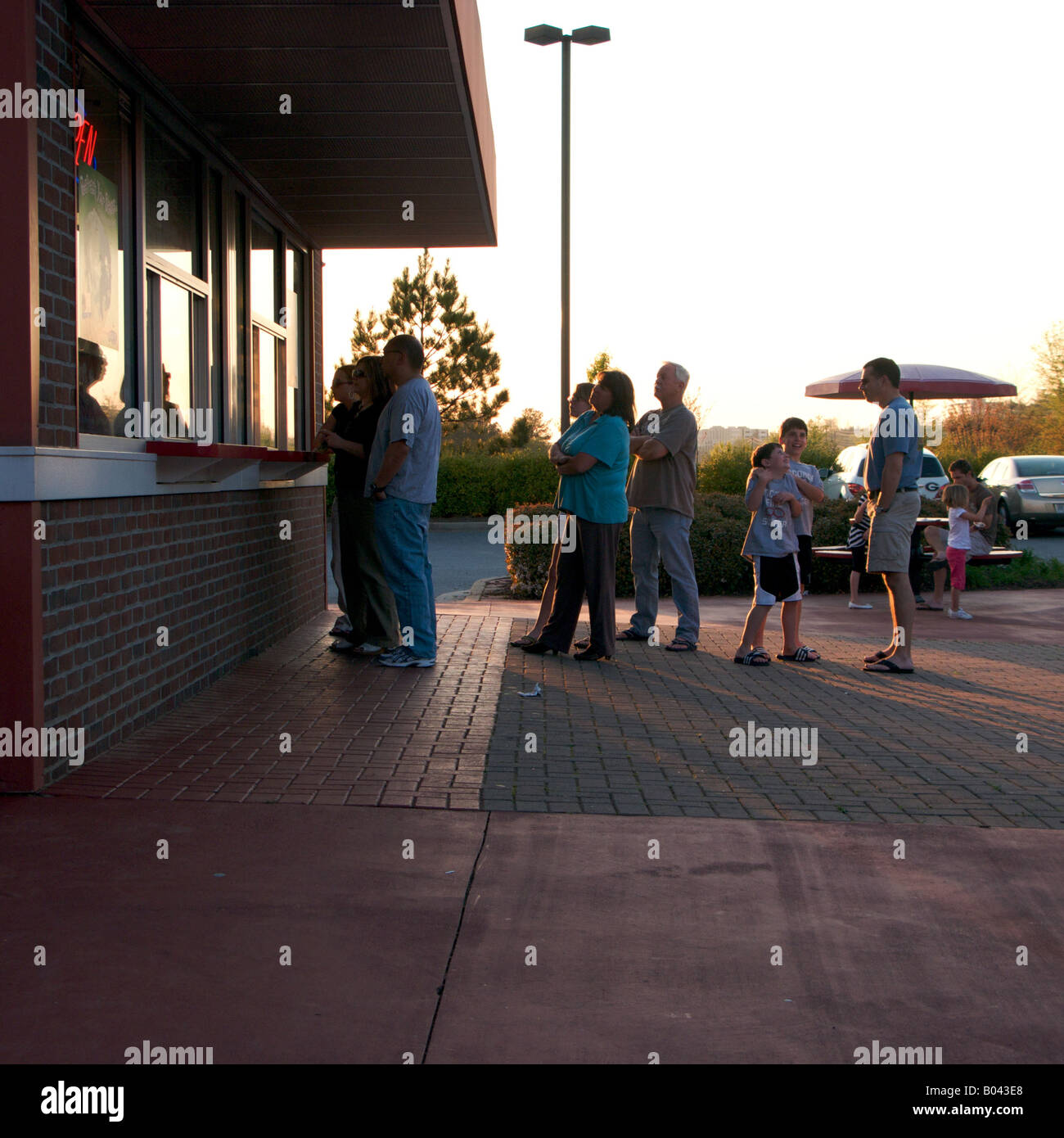 People waiting in line at ice cream shop Stock Photo - Alamy