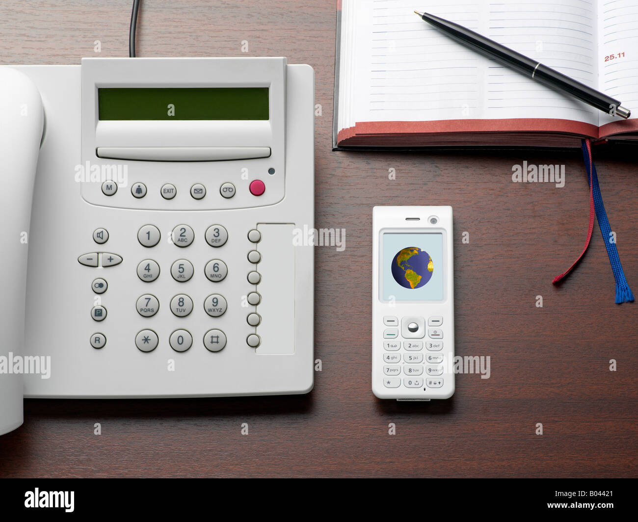 Telephone and Cellular Phone on Desk Stock Photo - Alamy