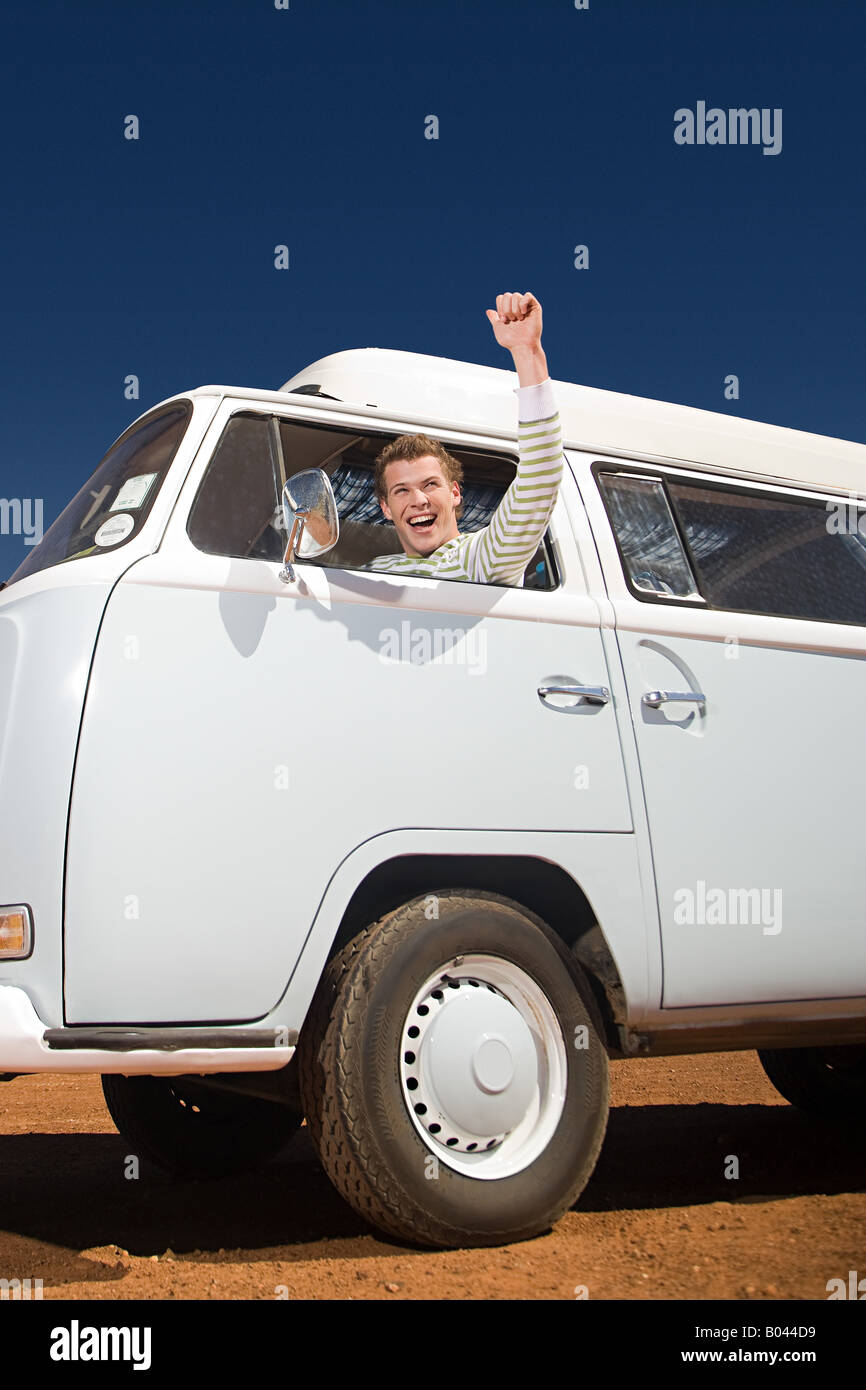 A young man driving a camper van Stock Photo - Alamy