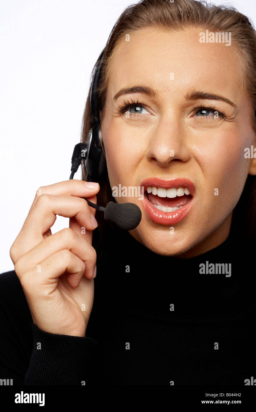 Angry Businesswoman Talking on Headset Stock Photo - Alamy