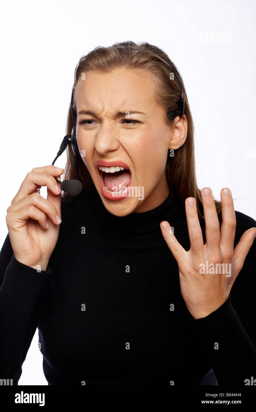 Angry Businesswoman Yelling Into Headset Stock Photo - Alamy