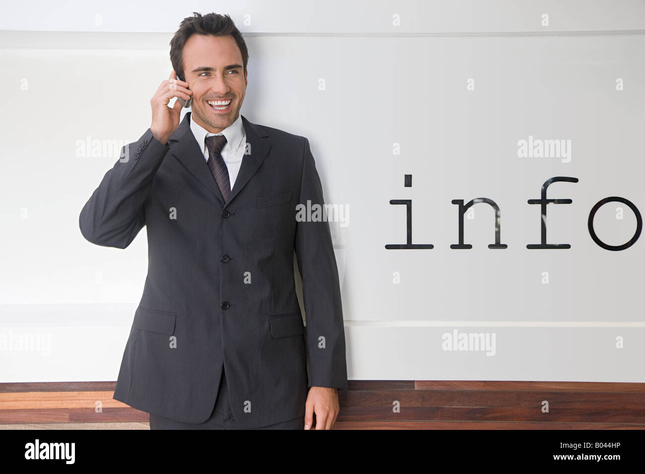 Businessman by information sign Stock Photo - Alamy