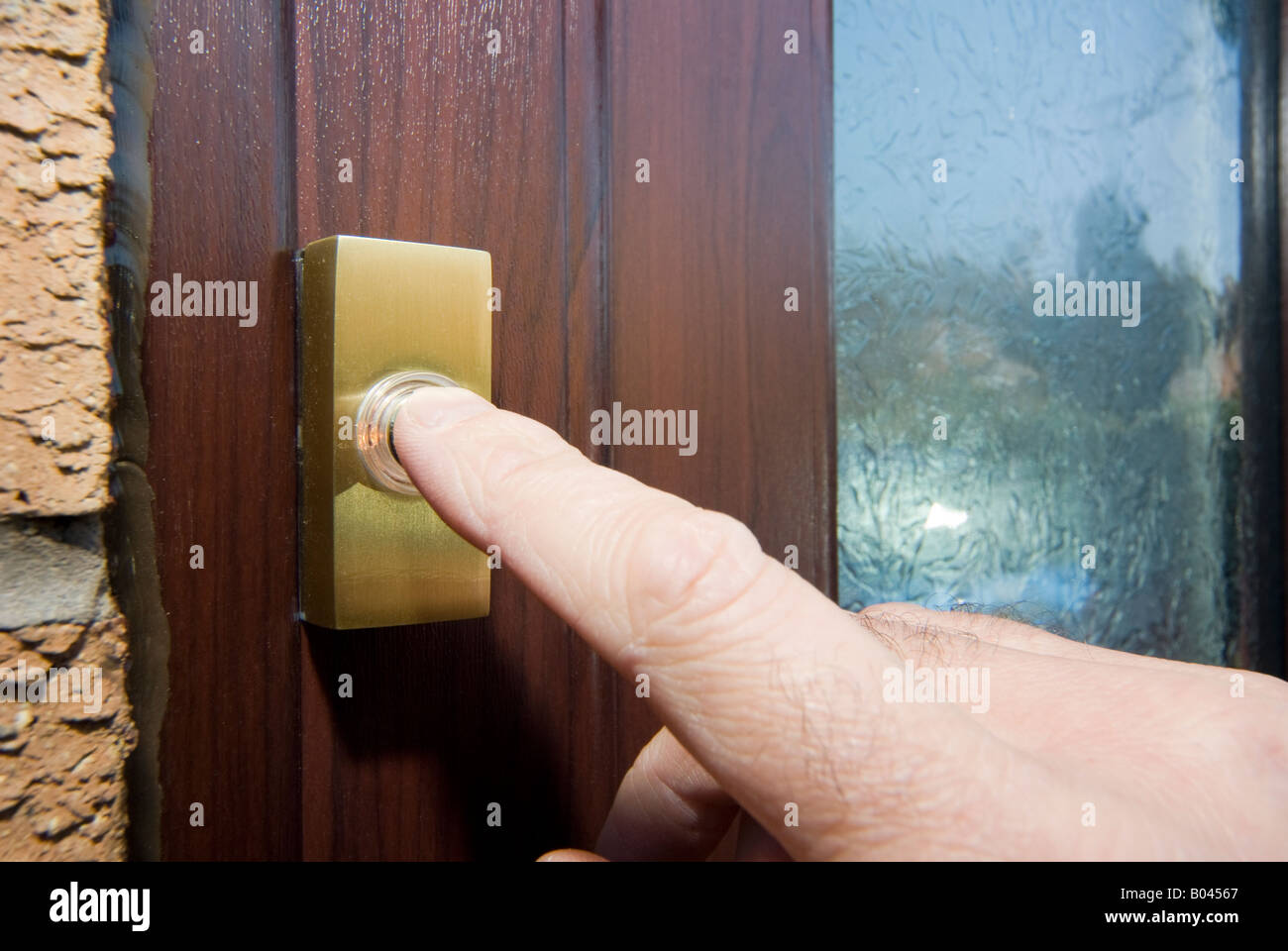 Pressing a doorbell outside a house in the uk Stock Photo - Alamy