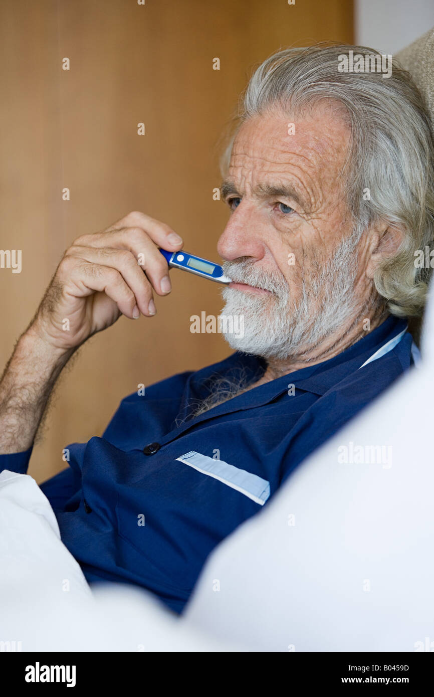 Man using thermometer Stock Photo - Alamy