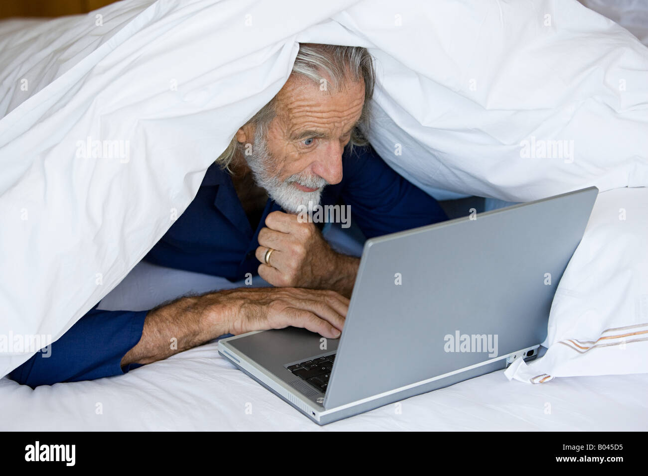 Man looking under covers bed hi-res stock photography and images - Alamy