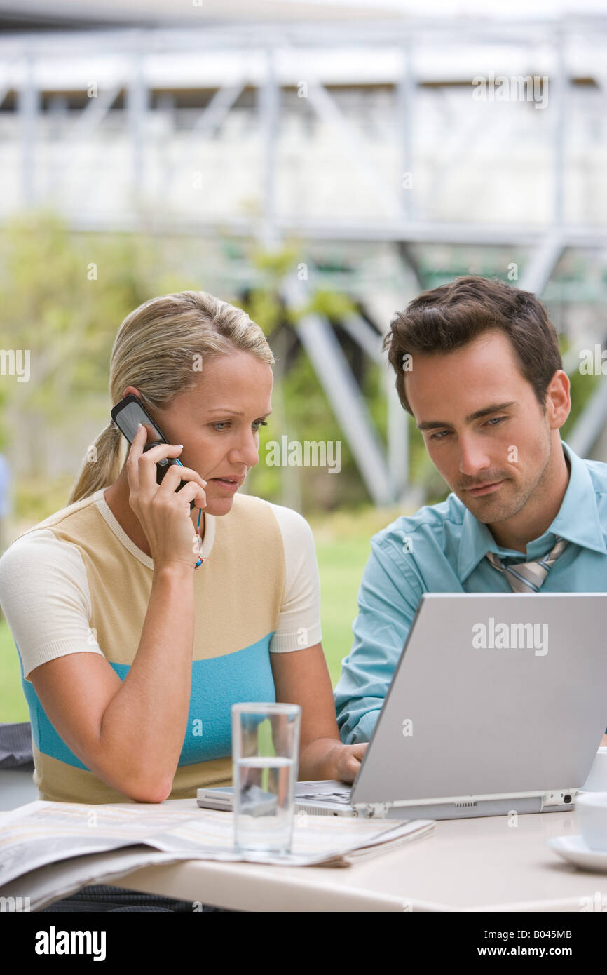 Colleagues using a laptop computer Stock Photo - Alamy
