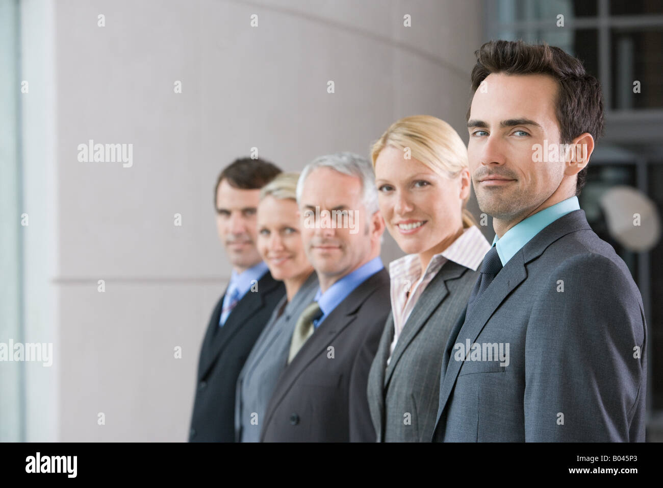 Five colleagues in a row Stock Photo - Alamy
