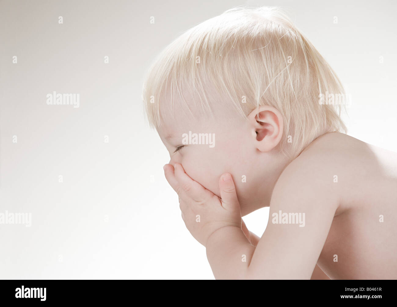 A baby boy covering his face Stock Photo - Alamy