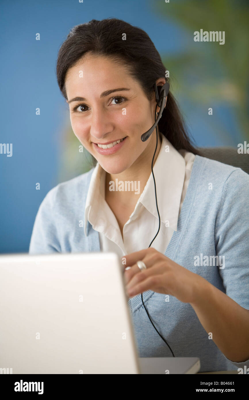 Woman with Headset and Laptop Computer Stock Photo - Alamy