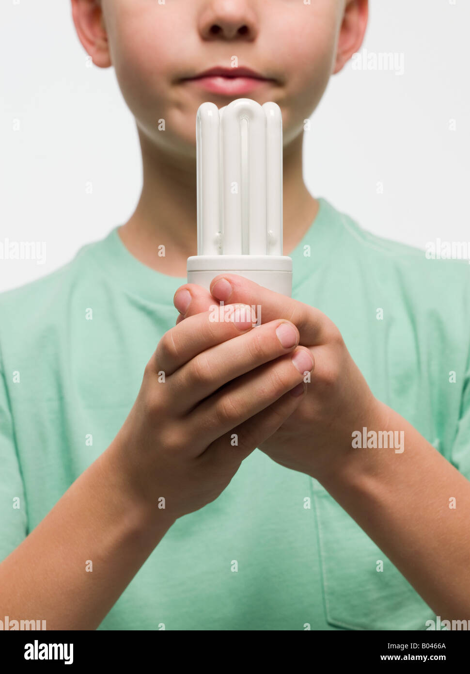Boy holding an energy saving lightbulb Stock Photo - Alamy