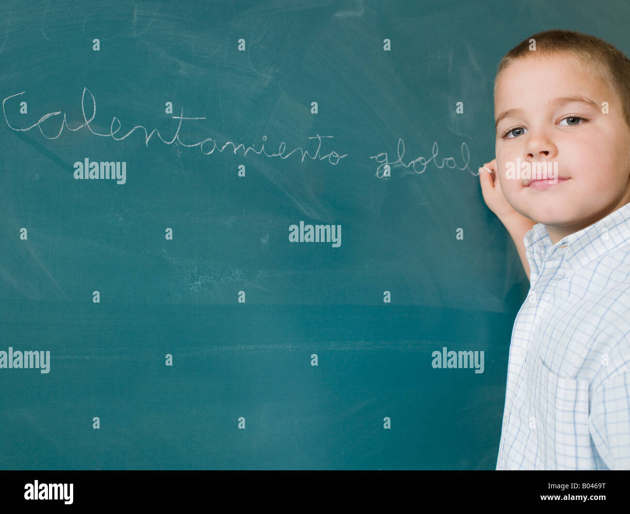 Boy writing on a blackboard Stock Photo - Alamy