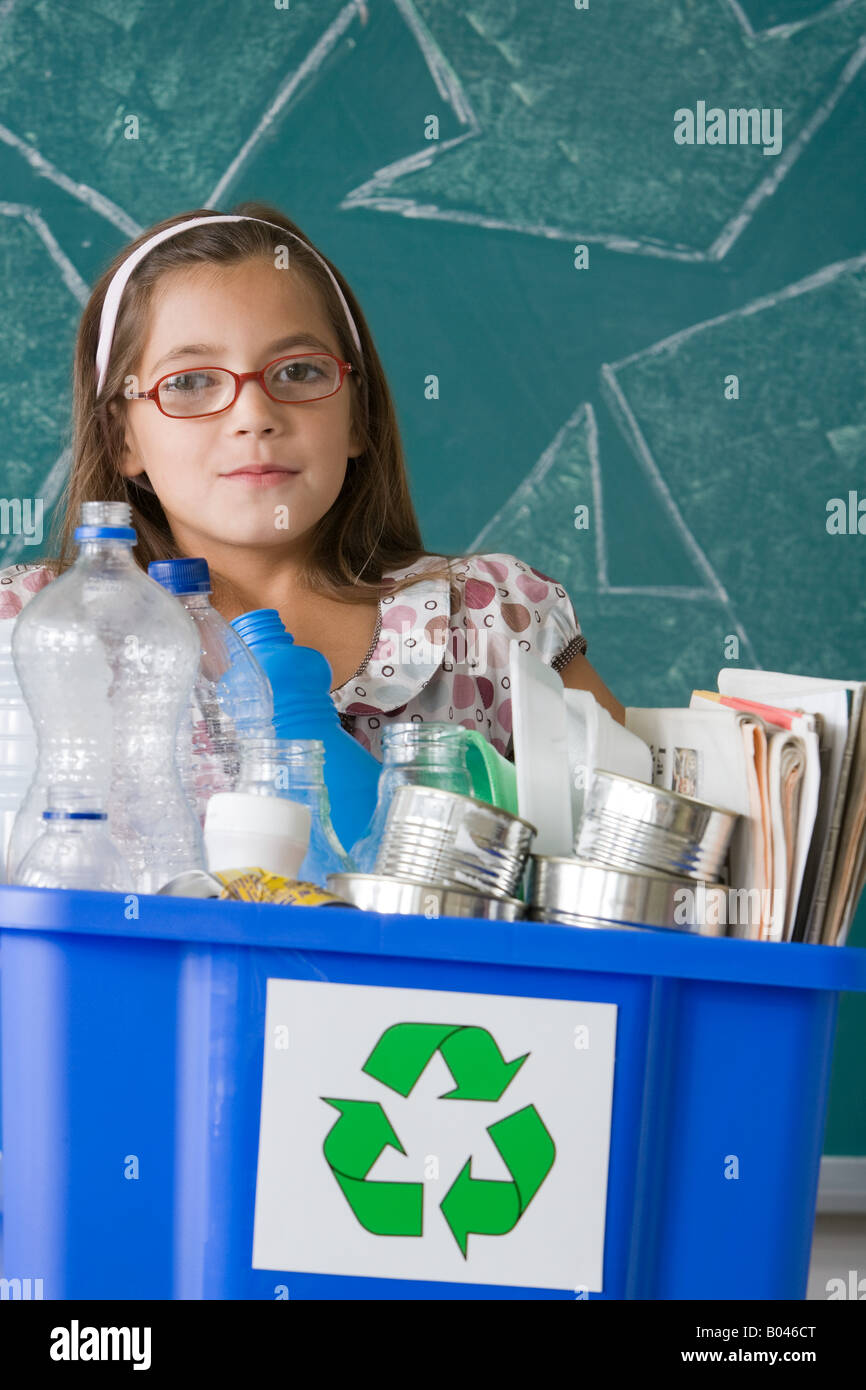 Girl holding a recycling bin Stock Photo - Alamy