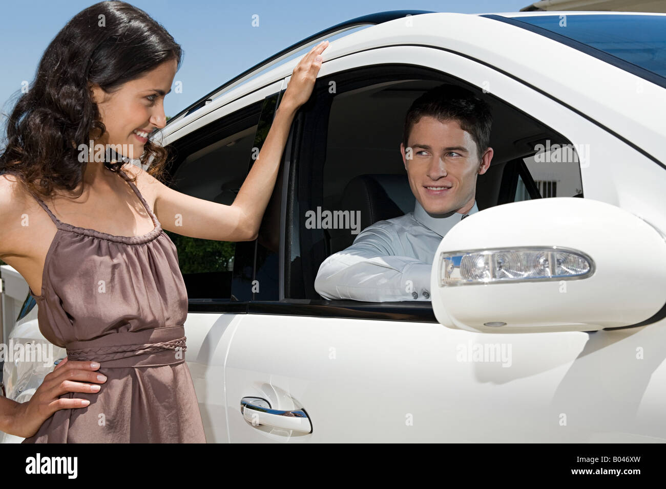 Flirty couple and car Stock Photo - Alamy